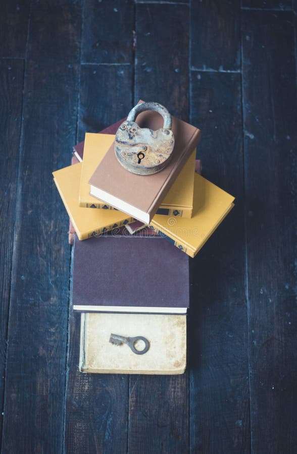 A Stack of Books, a Lock and a Key Lie on the Floor Stock Image - Image ...