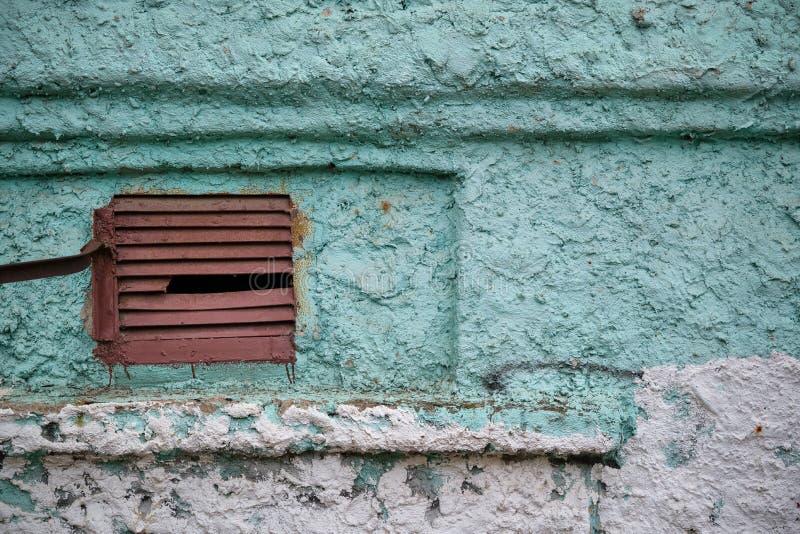 Old Brown Metal Grating with a Broken Compartment in a Concrete Wall ...