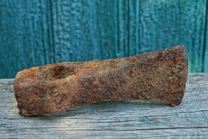 Old Brown Rusty Battle Ax on a Gray Board at the Green Wall Stock Photo ...