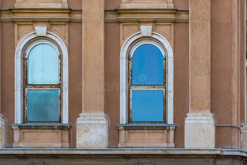 Old Building Facade with Blue Sky Reflection in Windows. One Open ...