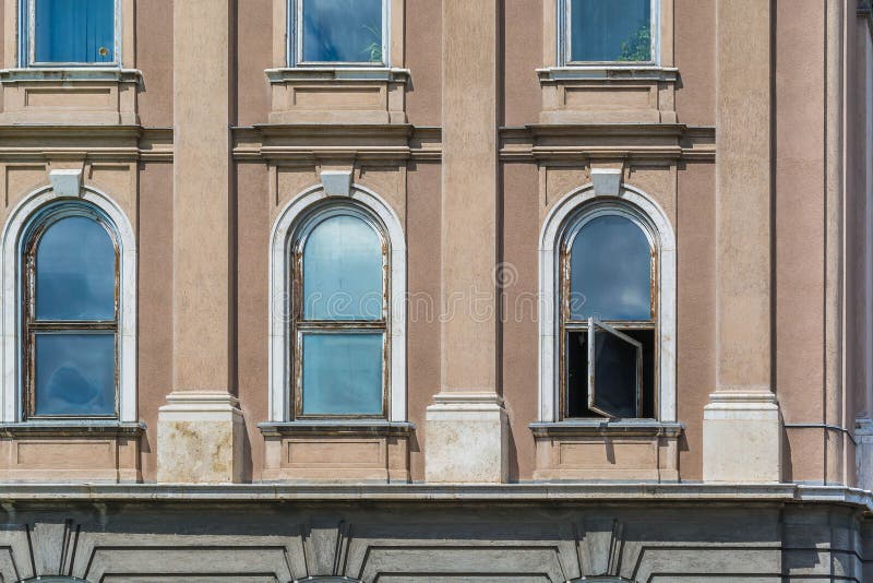 Old Building Facade with Blue Sky Reflection in Windows. One Open ...