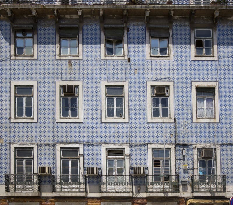 Old Building with Tiled Facade and Damaged Windows Stock Photo - Image ...