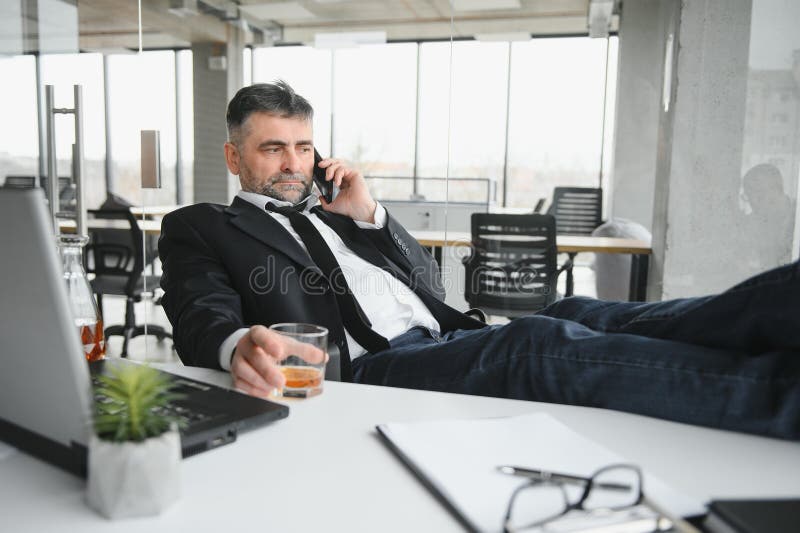 Old Business Man is Drinking Alchool at the Office Stock Photo - Image ...