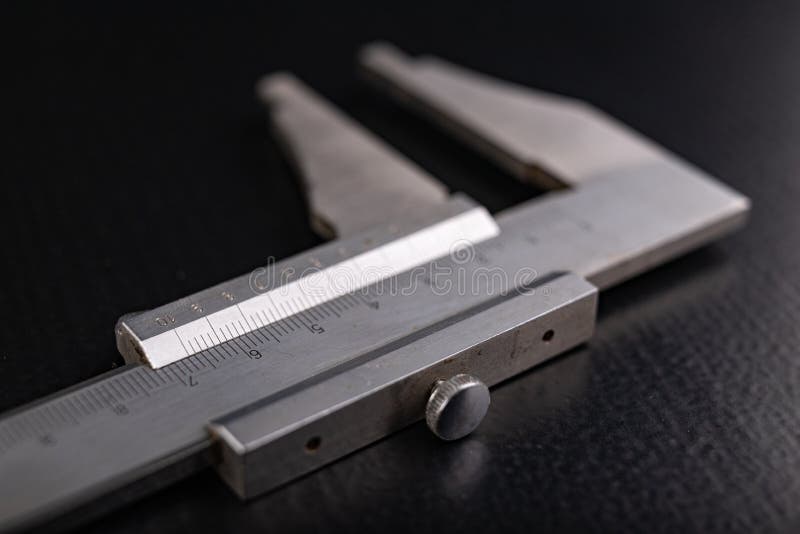 Old Caliper on a Dark Table. Traditional Measuring Accessories Stock ...