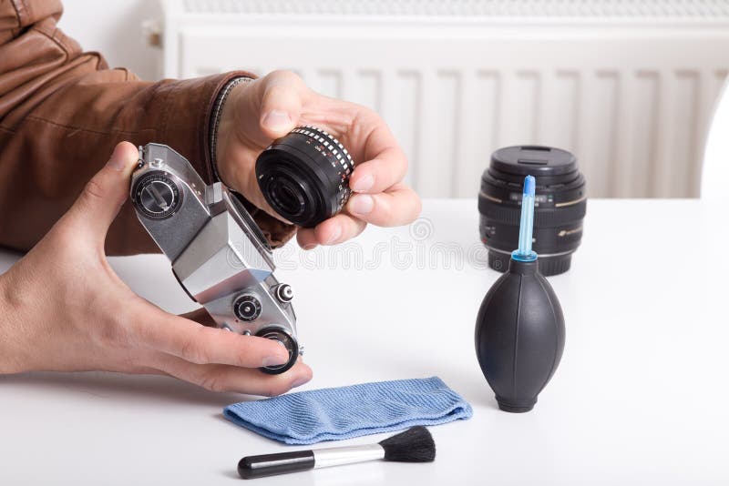 Old Camera and Lens in Male Hand Stock Image - Image of removing, dust ...