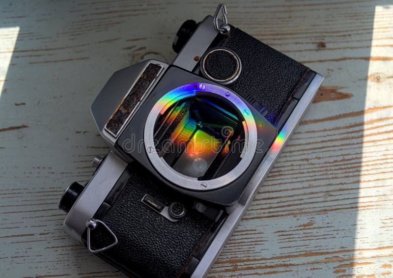 Old Camera Under Rainbow Color Sun Beam on Wooden Plank Texture. Stock ...