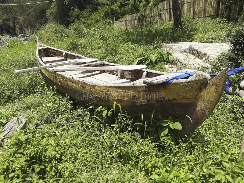 Old Canoe Stranded on Green Grass beside the River Stock Photo - Image ...
