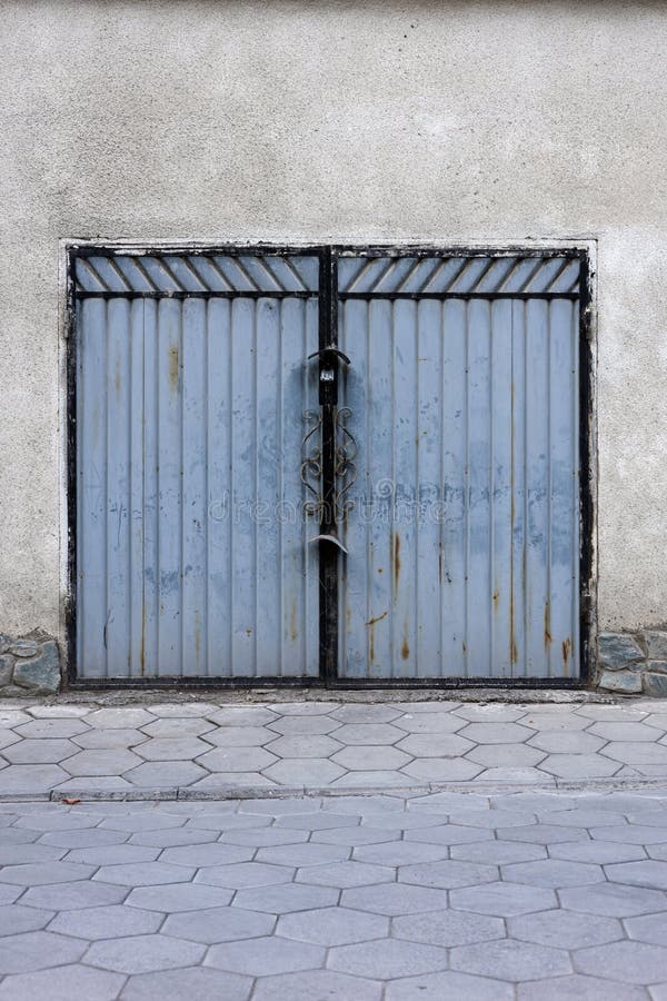 Old Car Garage Steel Doors Locked with a Lock in the Courtyard. Metal ...