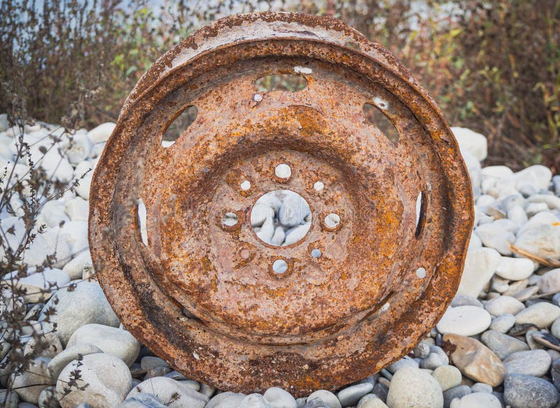 Old Car Wheel, Rusty Car Alloy Rim on Stones by the River Stock Image ...