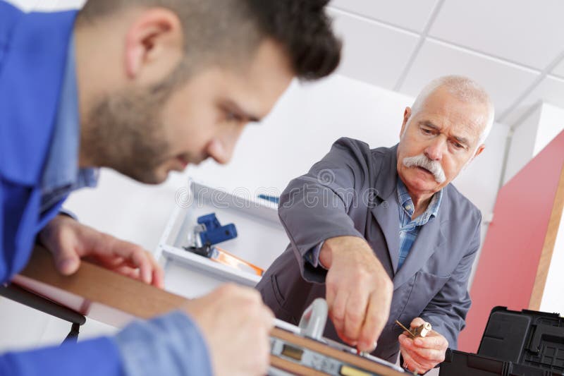Old Carpenter with Apprentice in Training Period Stock Image - Image of ...