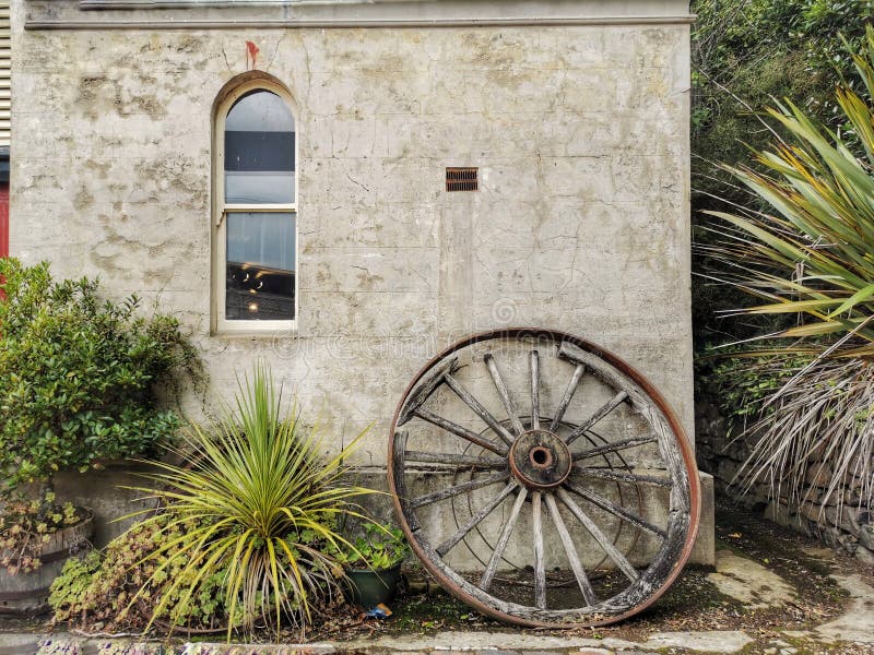 Old Cart Wheel by a Stone Garden Wall Stock Photo - Image of stone ...