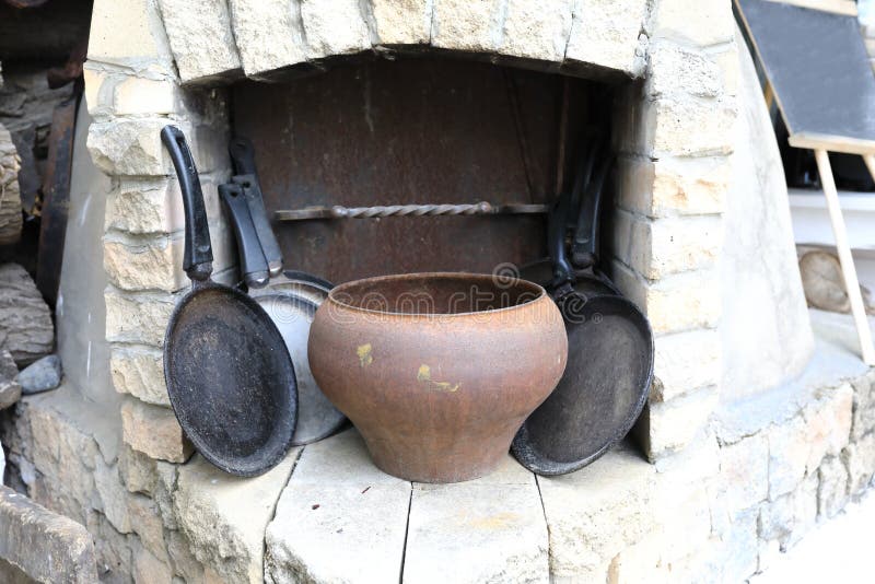 Old Cast Iron Cookware in Stone Oven Stock Photo - Image of abstract ...