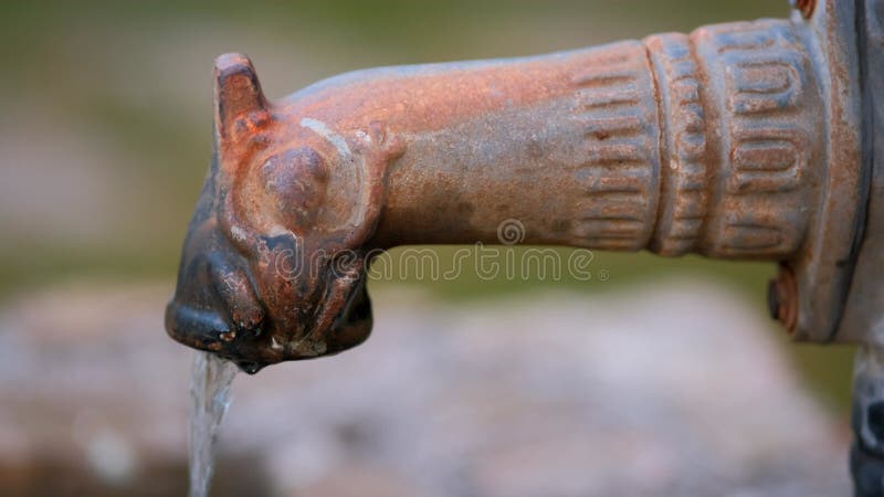 An Old Cast-iron Hand Pump Column with Flowing Water in Close-up Stock ...