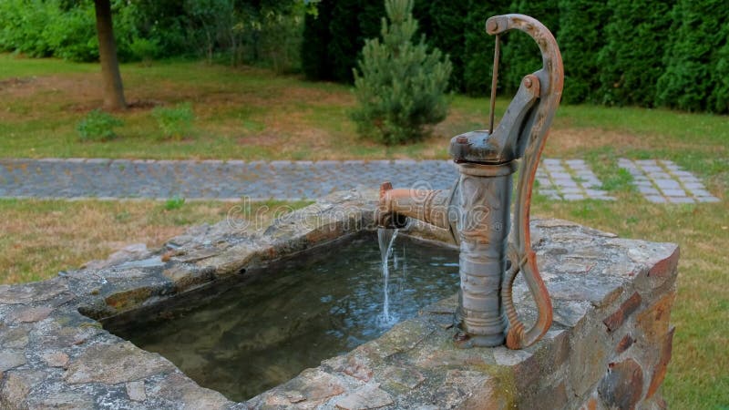 An Old Cast Iron Hand Pump Water Column is Equipped for a Decorative ...