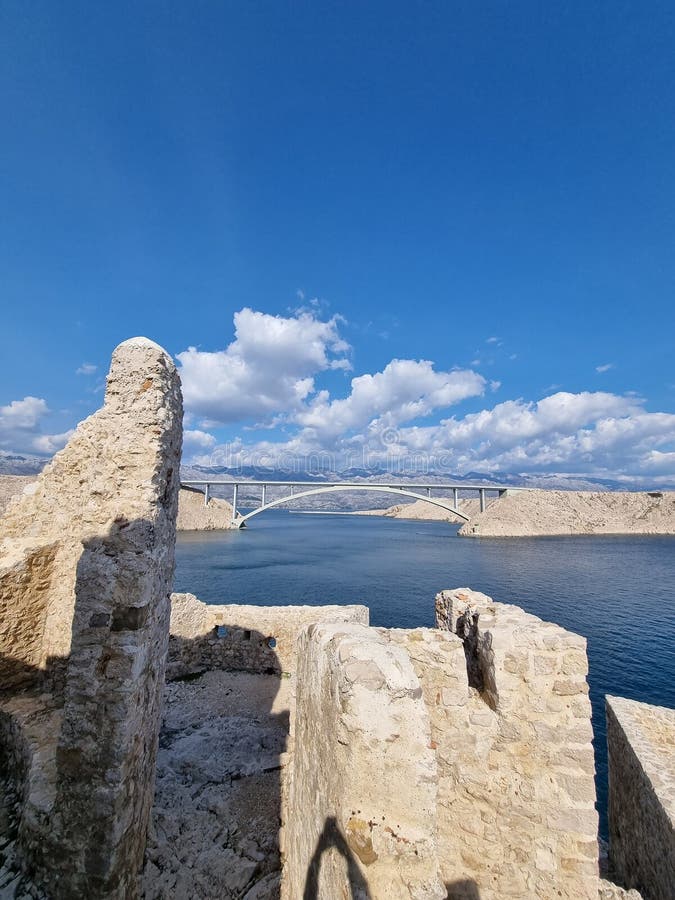 Old Castle Ruins and Bridge Over Calm Sea Stock Photo - Image of bridge ...