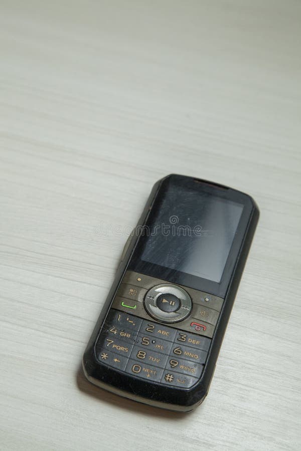 Old Cellular Device Placed on the Table Top in the Home Office Stock ...