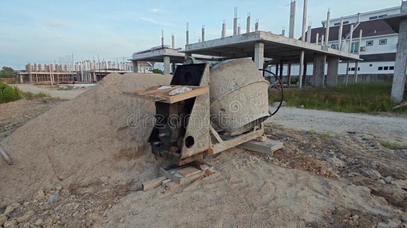 An Old Cement Mixer Machine by the Pile of Sand at the Construction ...