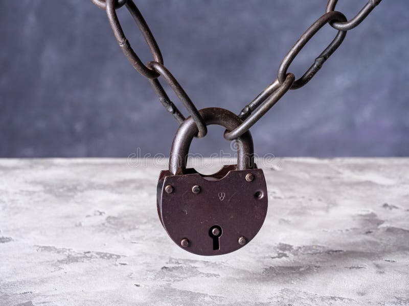 Old Chain Closed with a Rusty Padlock Hangs Above the Concrete Table ...