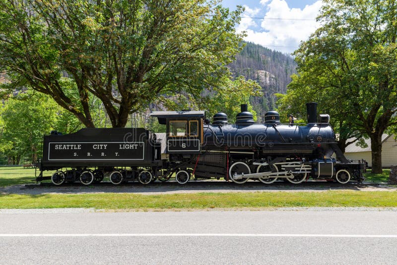 Old Chapel and an Old Train in Front of a Mountain and Trees. Editorial ...