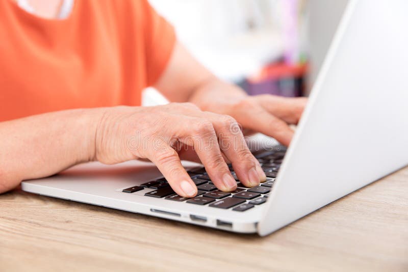 Old Chinese Lady is Sitting at the Computer and Typing Seriously Stock ...