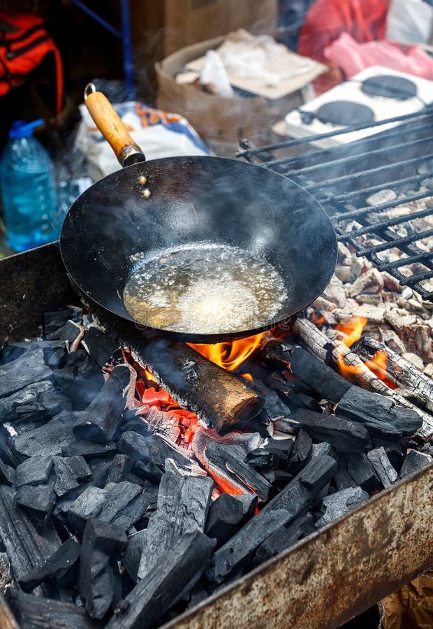 Old Chinese Wok Pan with Boiling Oil on a Fire Stock Image - Image of ...