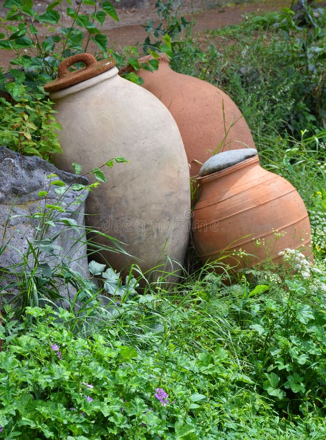 Old clay jugs in a garden stock image. Image of ground - 221599099