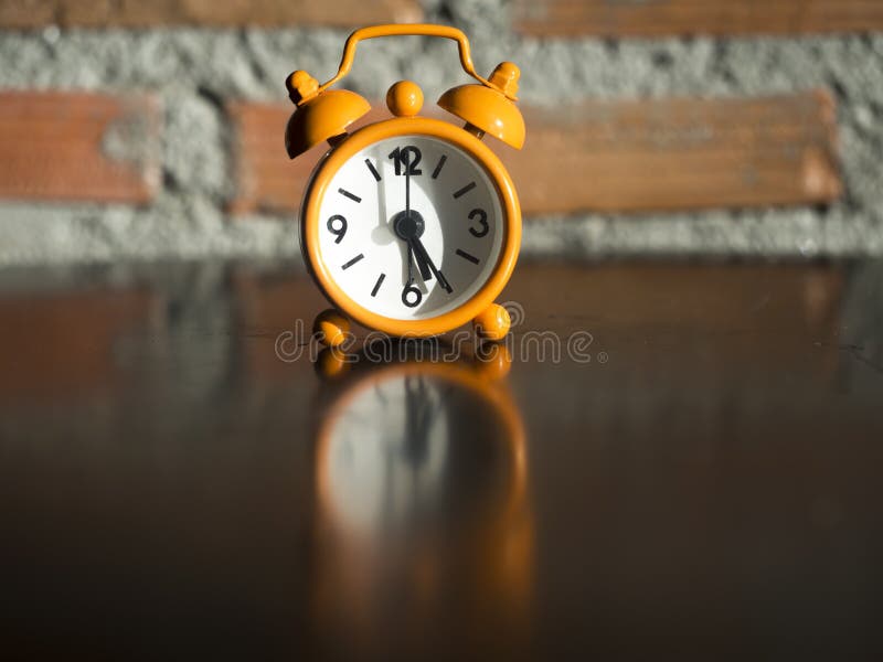 Old Clock Orange on the Wooden Table, Stock Image - Image of clocks ...