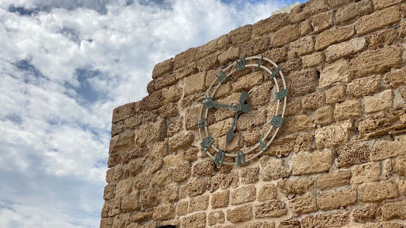 Clock on Rough Stone Wall. Exploring the North District in Israel ...