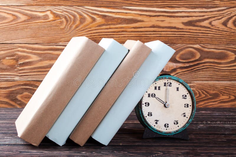 Old Clock and Stack of Old Books Stock Photo - Image of paper, table ...