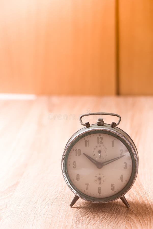 Old clock on wood table stock photo. Image of retro, vintage - 65613308