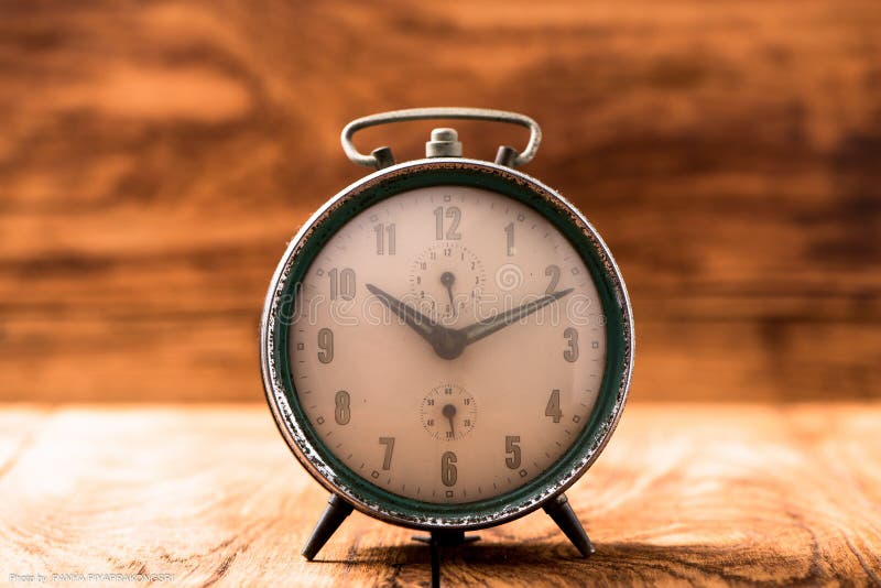 Old clock on wood table stock image. Image of vintage - 65617217