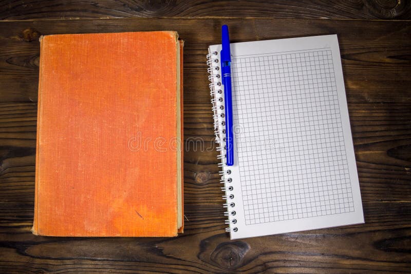 Old Closed Book, Notepad and Pen on Wooden Desk Stock Image - Image of ...