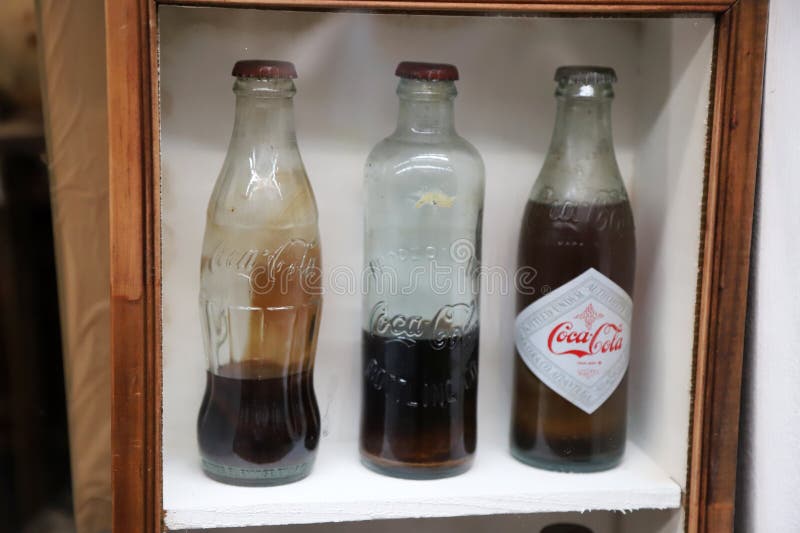Old Coca Cola Bottles of Different Models. Soda Drinks Editorial Stock ...