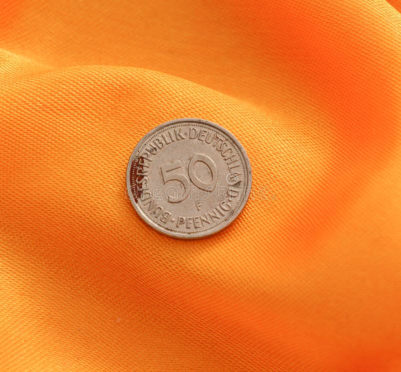Old coin on yellow fabric stock image. Image of payment - 78418261