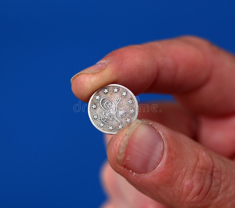 Old coins on a fingers stock image. Image of coin, interest - 76276805