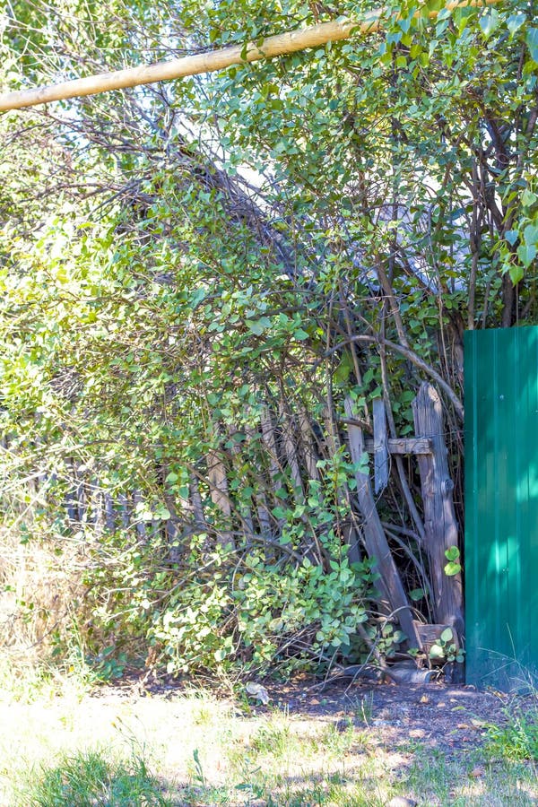 The Old and almost Collapsed Fence Stands Next To the New One. Stock ...