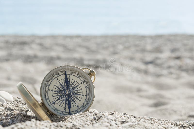 Compass On The Beach With Sand And Sea Stock Image - Image of adventure ...
