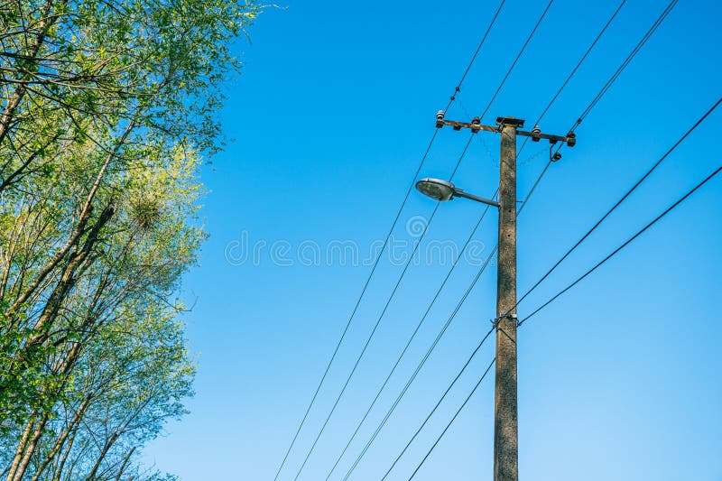 Old Concrete Lamp Post with Street Light and Messy Electrical Wires ...