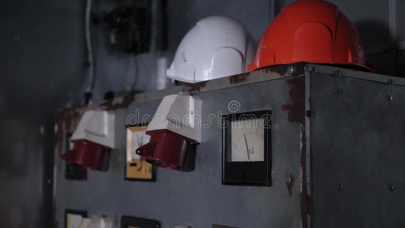 An Old Control Panel with Measuring Instruments and Old Helmets in a ...
