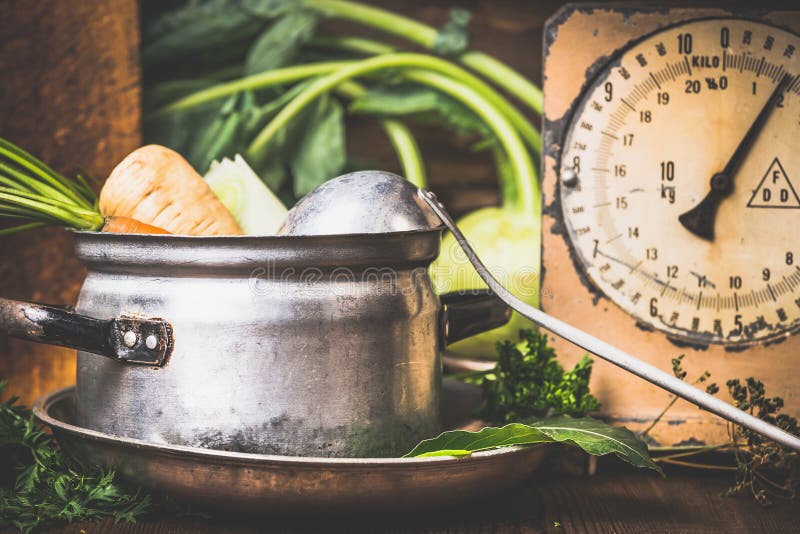 Old Cooking Pot with Raw Vegetables and Ladle on Rustic Kitchen Table ...