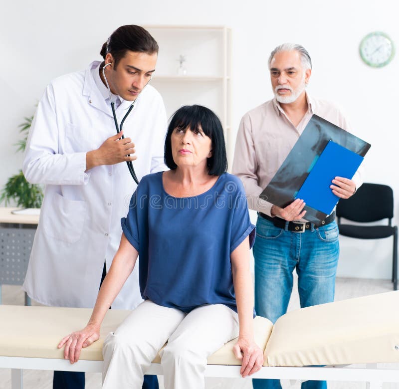 Old Couple Visiting Young Male Doctor Stock Image - Image of insurance ...