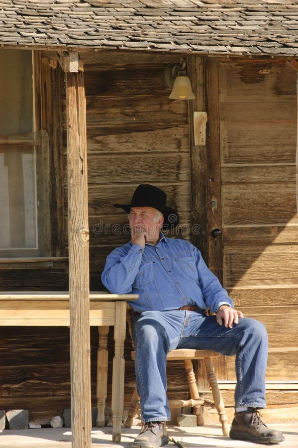 Old Cowboy stock photo. Image of blue, sitting, building - 26692380