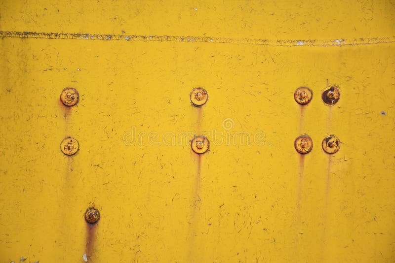 Old, Cracked Yellow Paint with Rust Stains from Rivets. Stock Photo ...