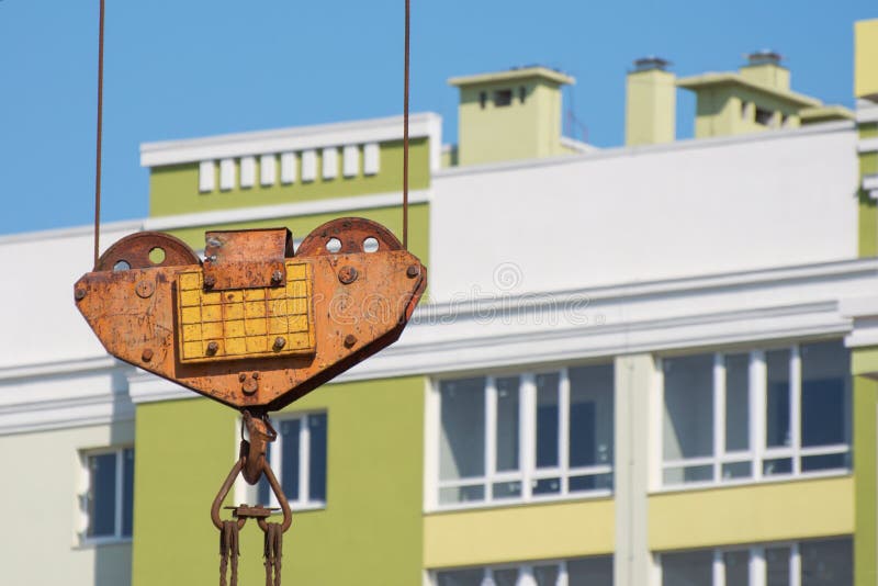 Old Crane Hook is Lifting Building Materials. the Construction of a ...