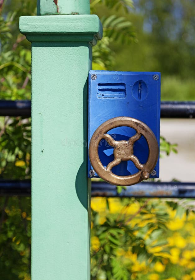 An Old Crank with a Coin Drop Stock Photo - Image of single, trees ...