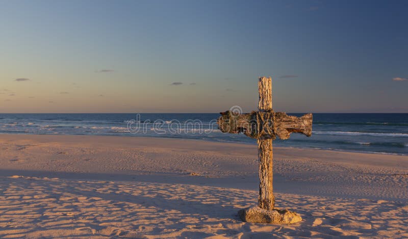 An Old Cross on Sand Dune Next To the Ocean with a Calm Sunrise Stock ...