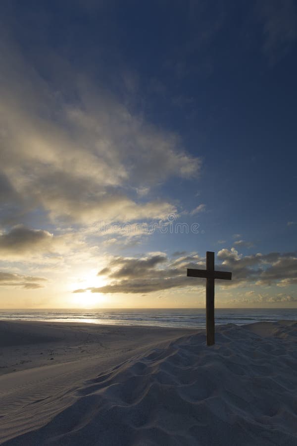 An Old Cross on Sand Dune Next To the Ocean with a Calm Sunrise Stock ...