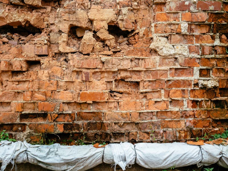 An Old, Crumbling Brick Wall and a Heating Main Passing by Stock Photo ...