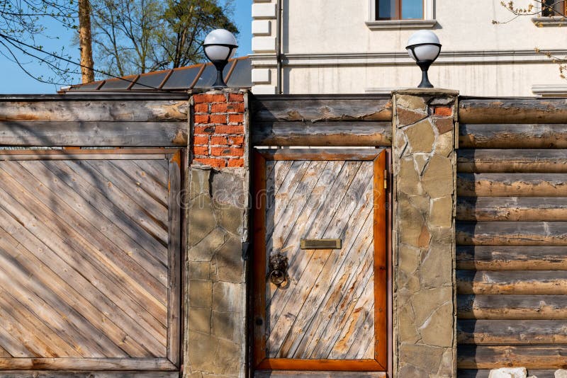 Old Crumbling Wooden Fence and Massive Door Stock Photo - Image of lamp ...