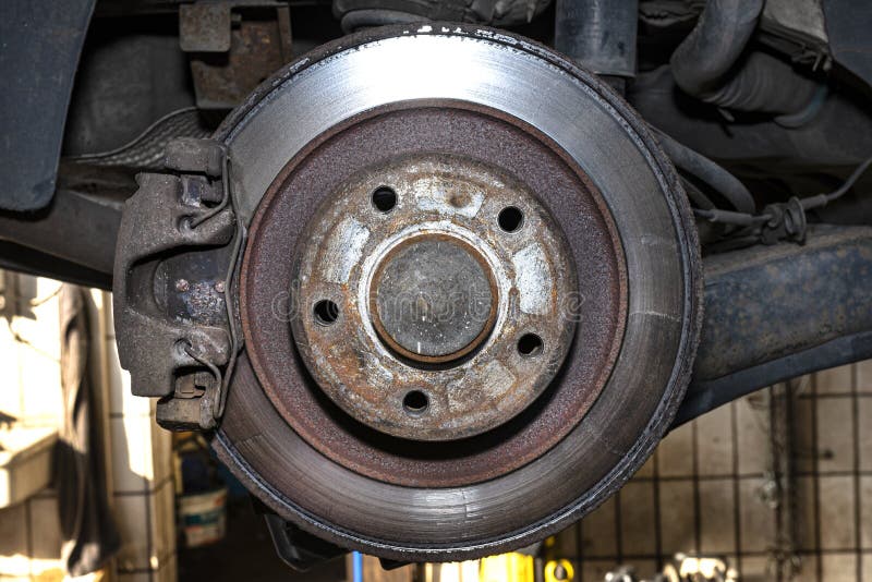Old and Damaged Rear Brake Discs with Caliper and Brake Pads in the Car ...